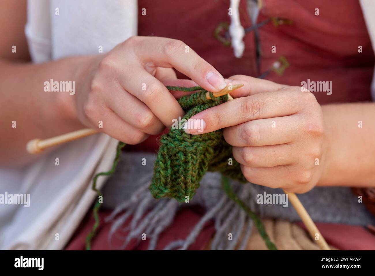 Detail of hands knitting with yarn and needles Stock Photo - Alamy
