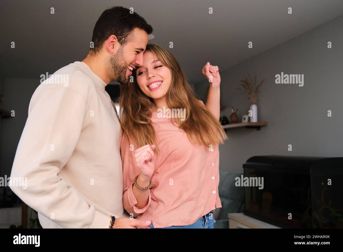 Spanish couple dancing and laughing together at home Stock Photo - Alamy