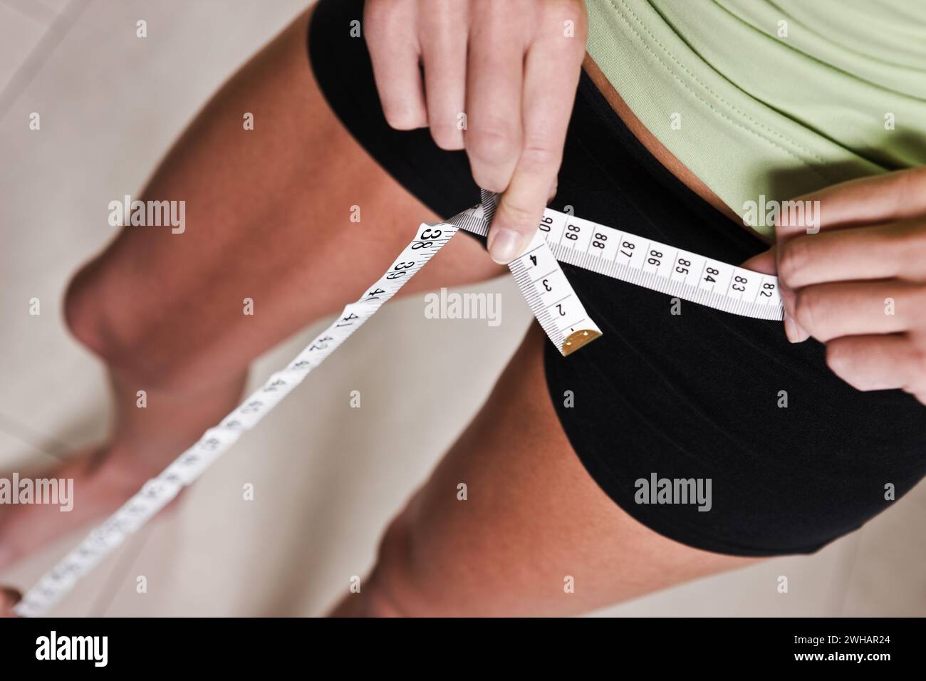 Measuring hip with tape measure Stock Photo - Alamy