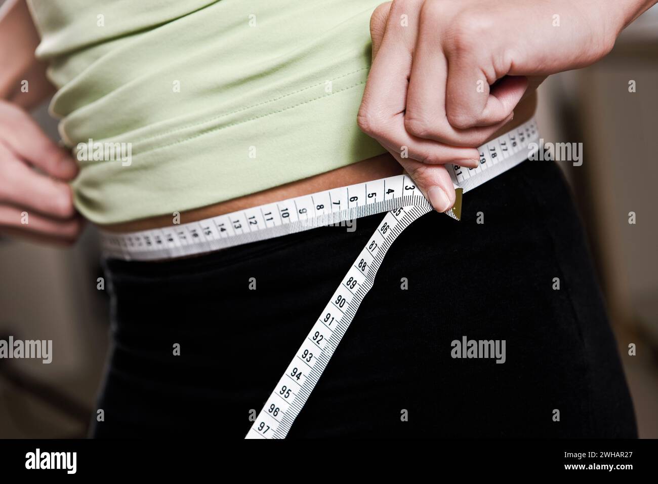 Measuring hip with tape measure Stock Photo - Alamy