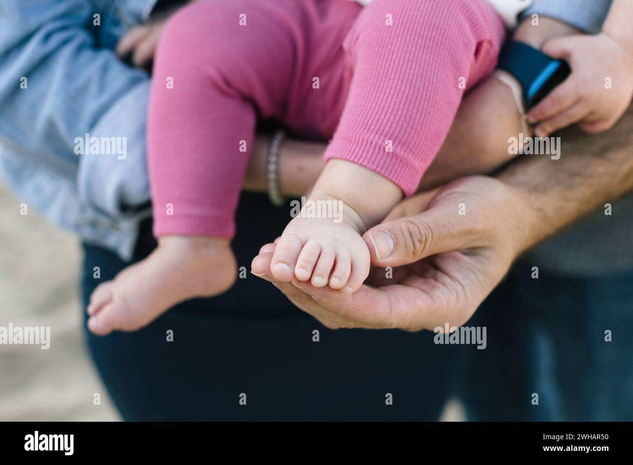 Close Up Of An Infant Girl's Toes While Her Father Holds Her Foot Stock ...