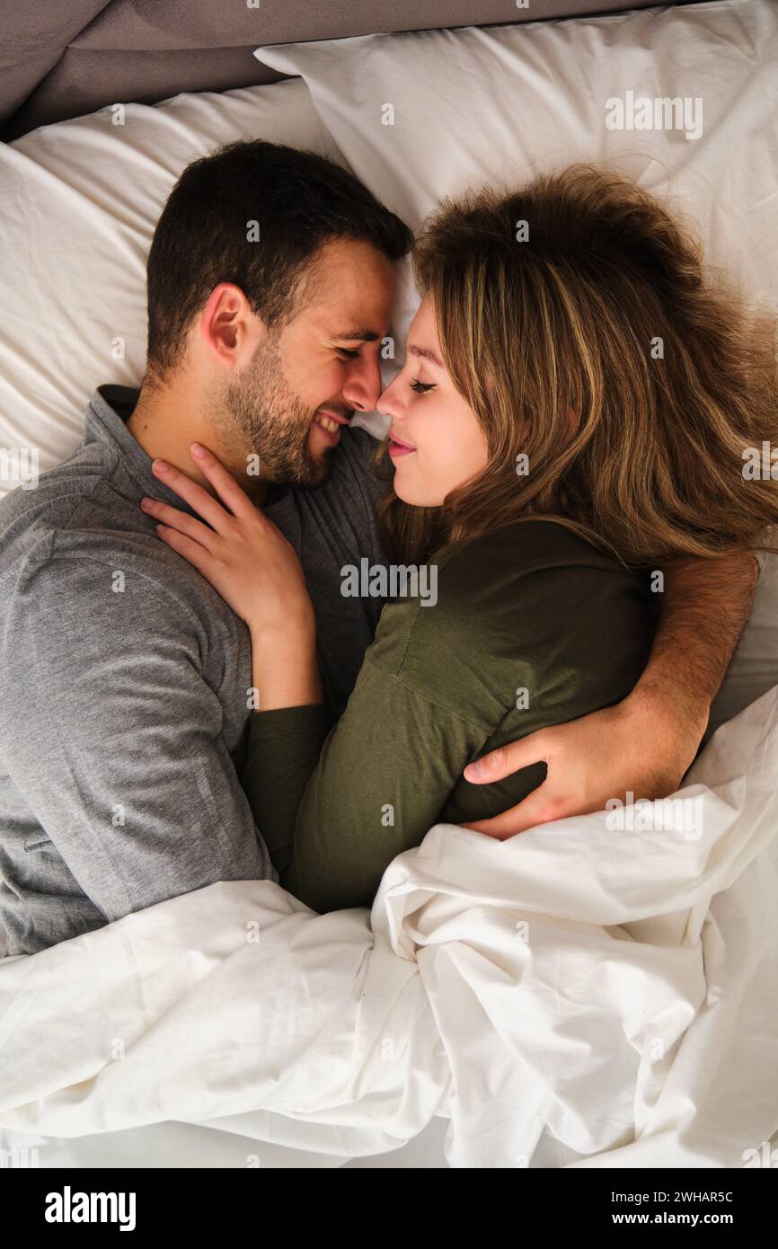 Couple hug bed hi-res stock photography and images - Alamy