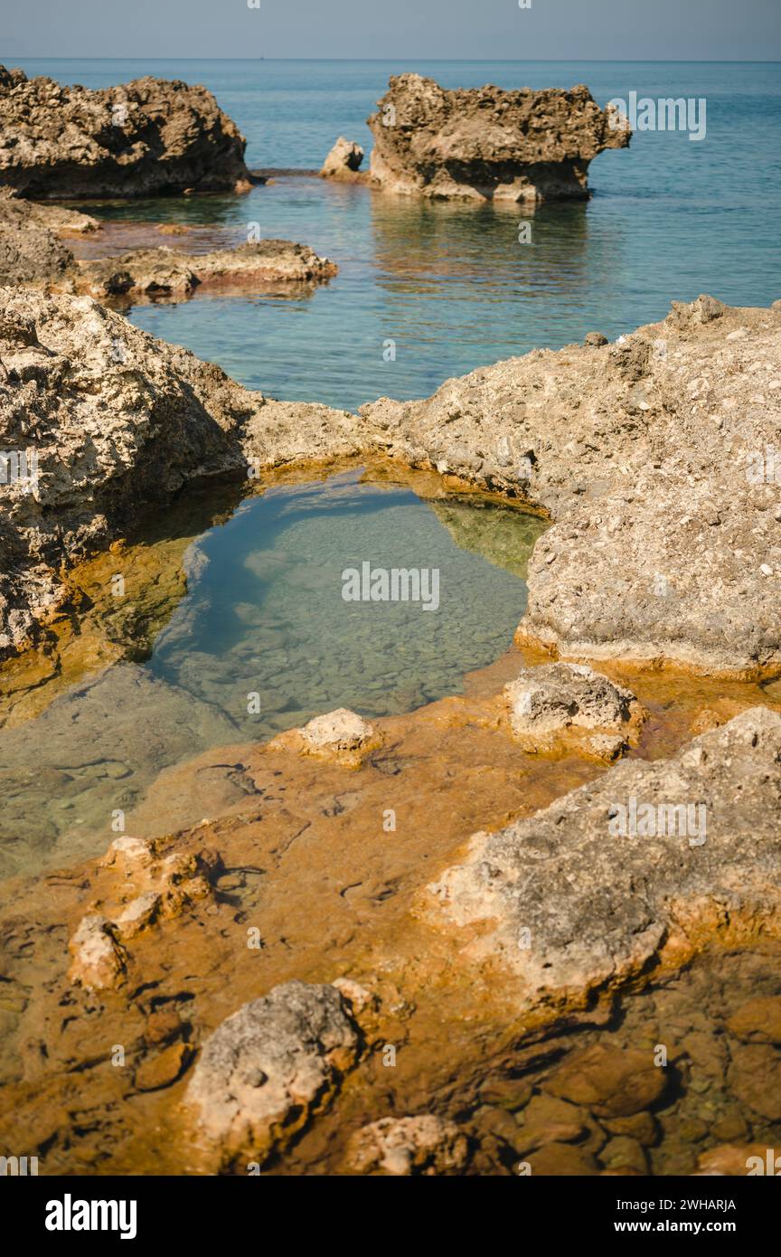 Tide pools of sea water along the rocky shore of the island of Crete ...
