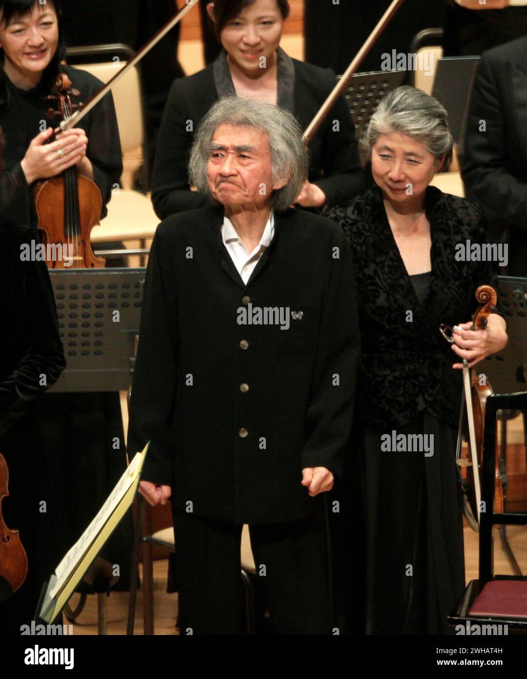 FILE - Seiji Ozawa, center, reacts as he greets the audience after a performance with ...