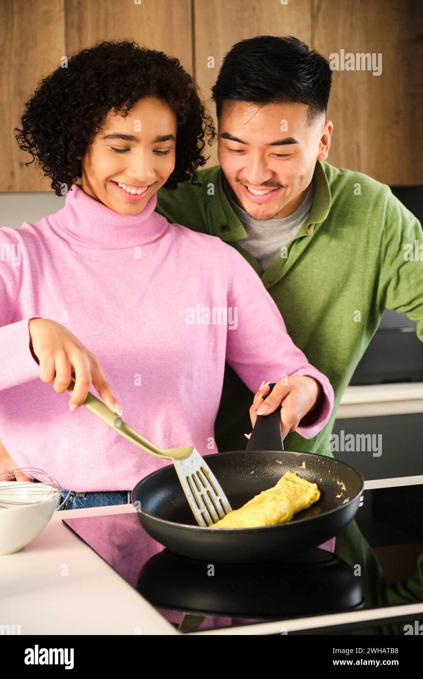 Diverse couple cooking hi-res stock photography and images - Alamy