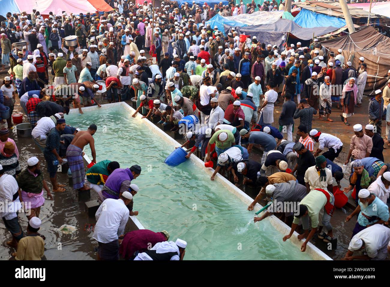 Tongi, Gazipur, Bangladesh. 9th Feb, 2024. Devotees using water from ...