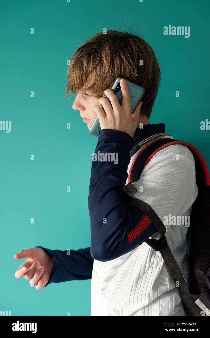 Teenager on the phone, texting, playing with his smartphone Stock Photo ...