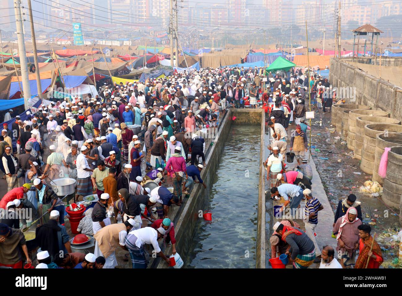 Tongi, Gazipur, Bangladesh. 9th Feb, 2024. Devotees using water from ...