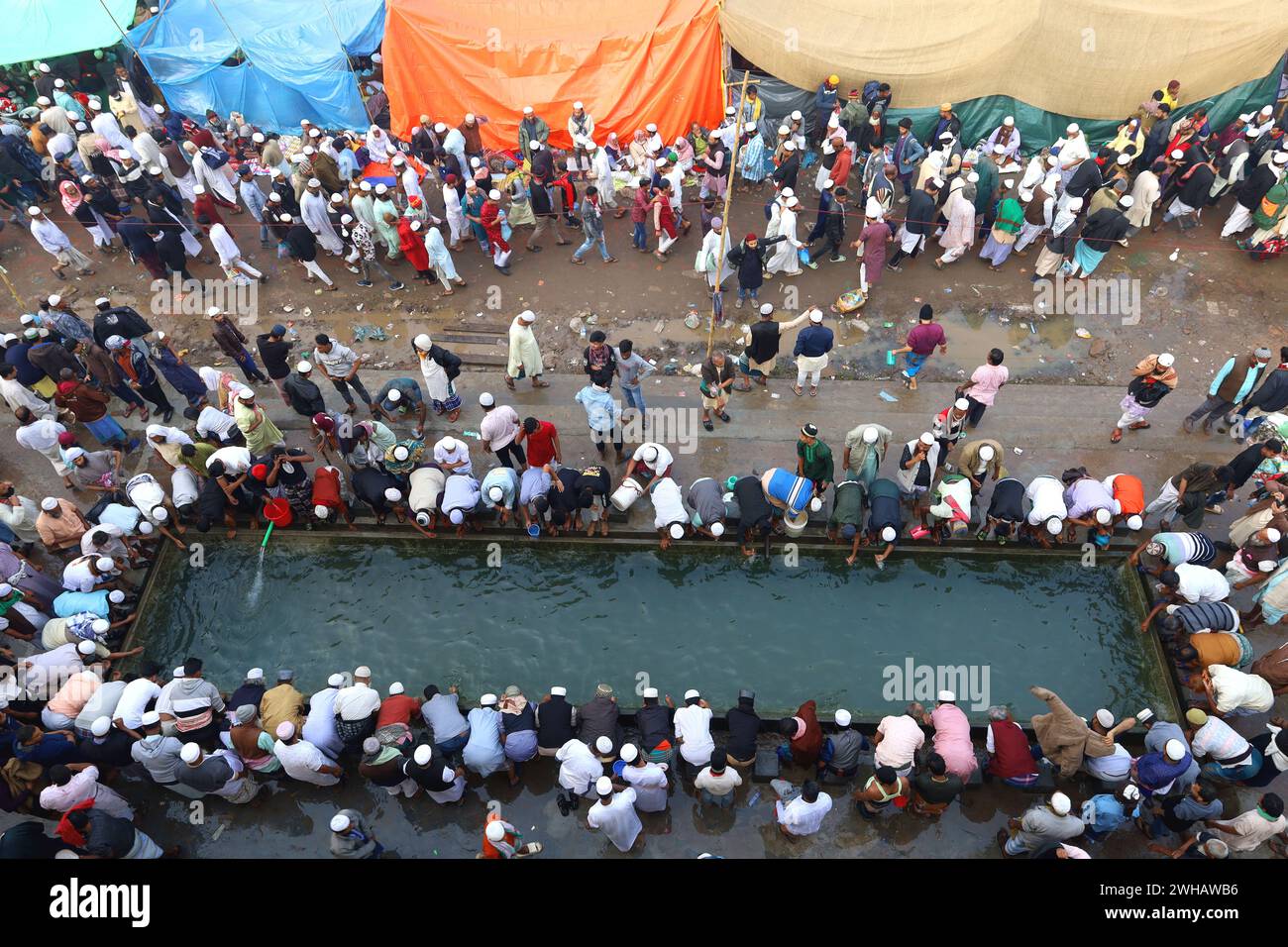 Tongi, Gazipur, Bangladesh. 9th Feb, 2024. Devotees using water from ...