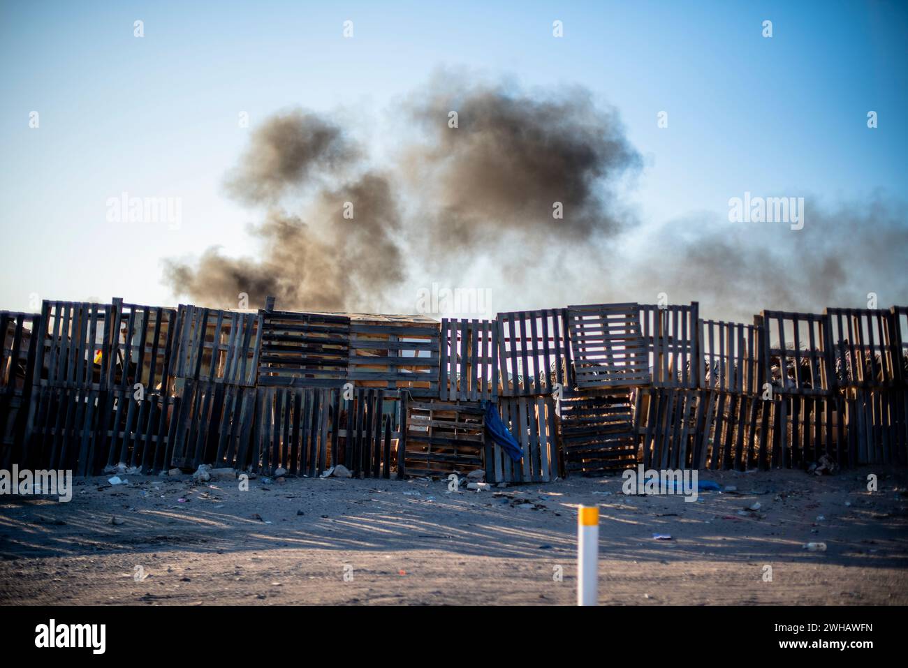barricade made of old wooden pallets separate the road from accidental ...