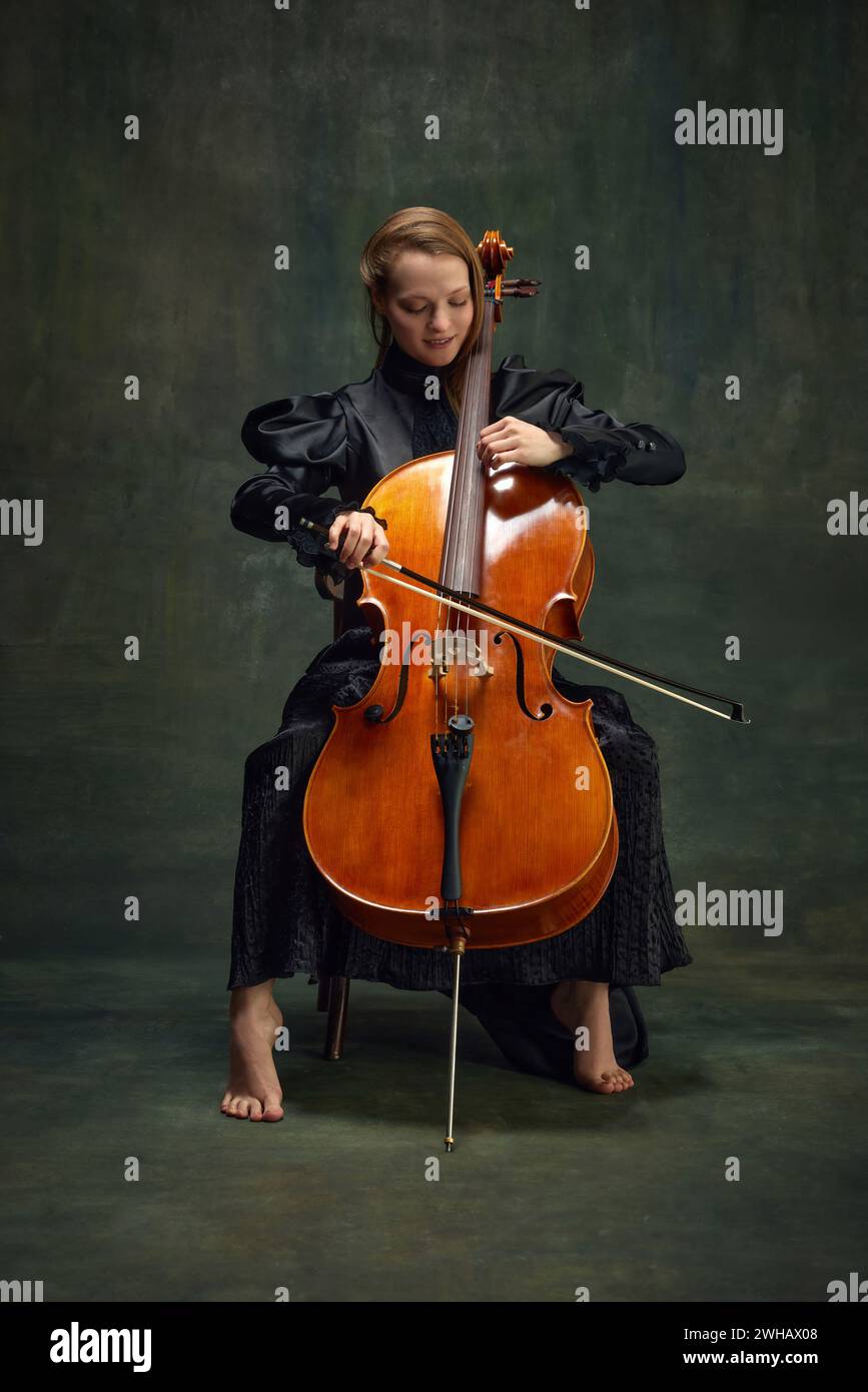 Beautiful young woman playing cello classical music instrument Stock ...