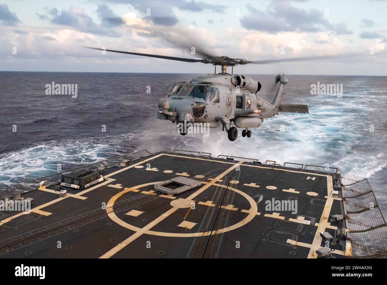 MH-60R Sea Hawk approaches the flight deck USS Dewey (DDG 105) in the ...