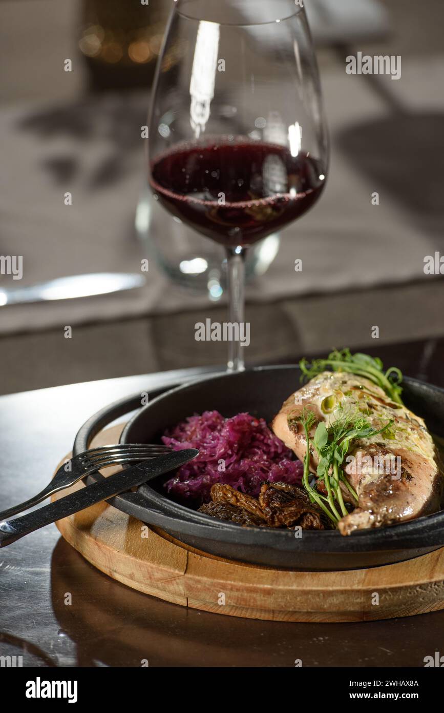 Chicken leg stuffed, served with vegetables on a black plate Stock ...