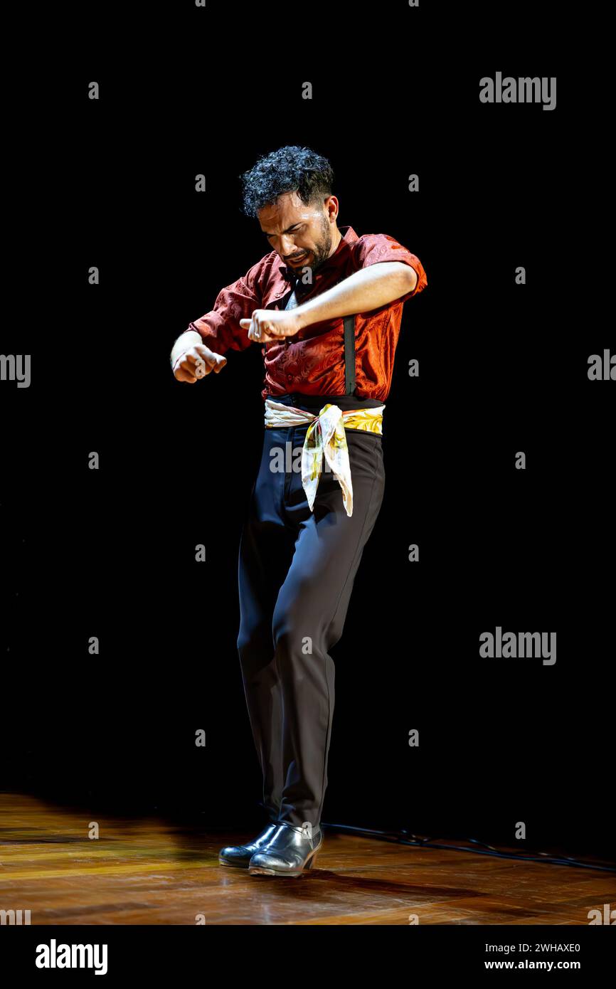 A male flamenco dancer exudes intensity and concentration, with arms ...