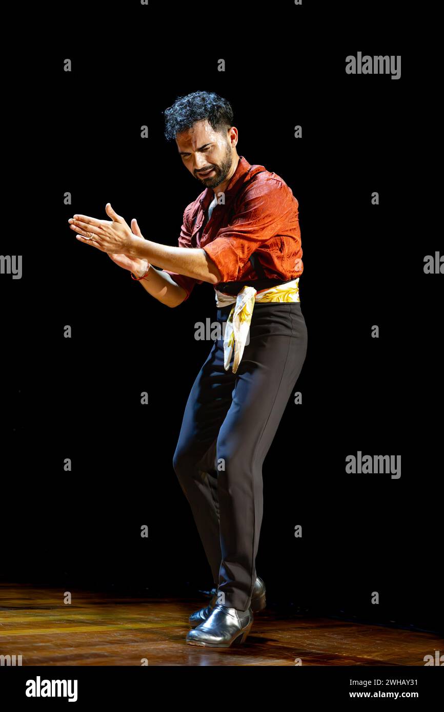 A male flamenco dancer, dressed in a red shirt, displays precision and ...