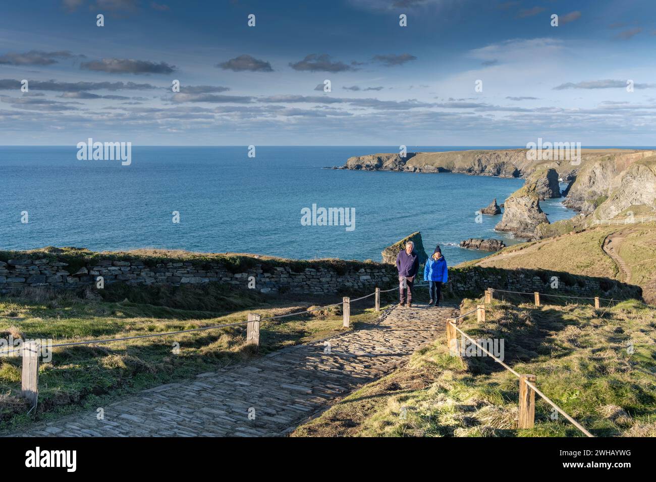 Walkers walking up a footpath from Bedruthan Steps on the dramatic ...