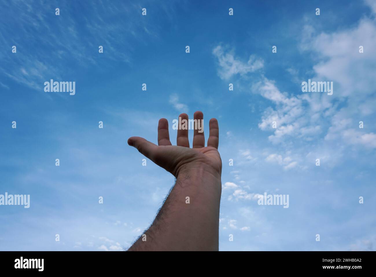 man hand gesturing and reaching the blue sky Stock Photo - Alamy