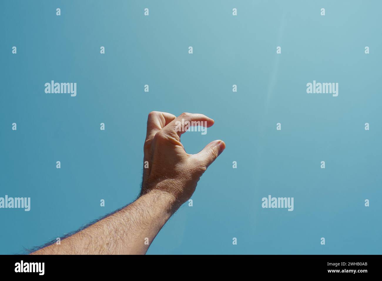man hand gesturing and reaching the blue sky Stock Photo - Alamy