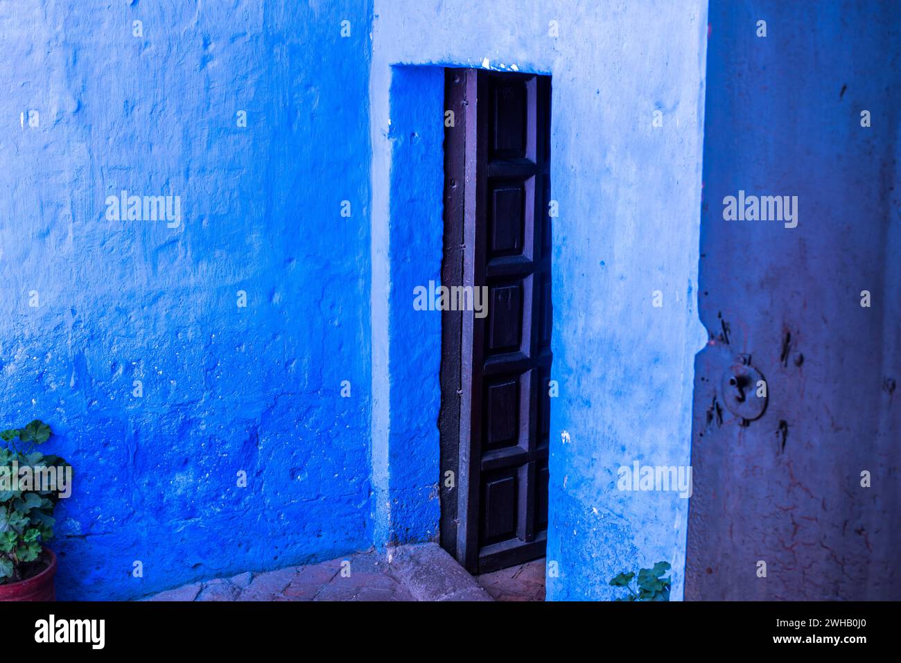 ancient doors on red and blue walls inside a monastery in Cusco Inca ...