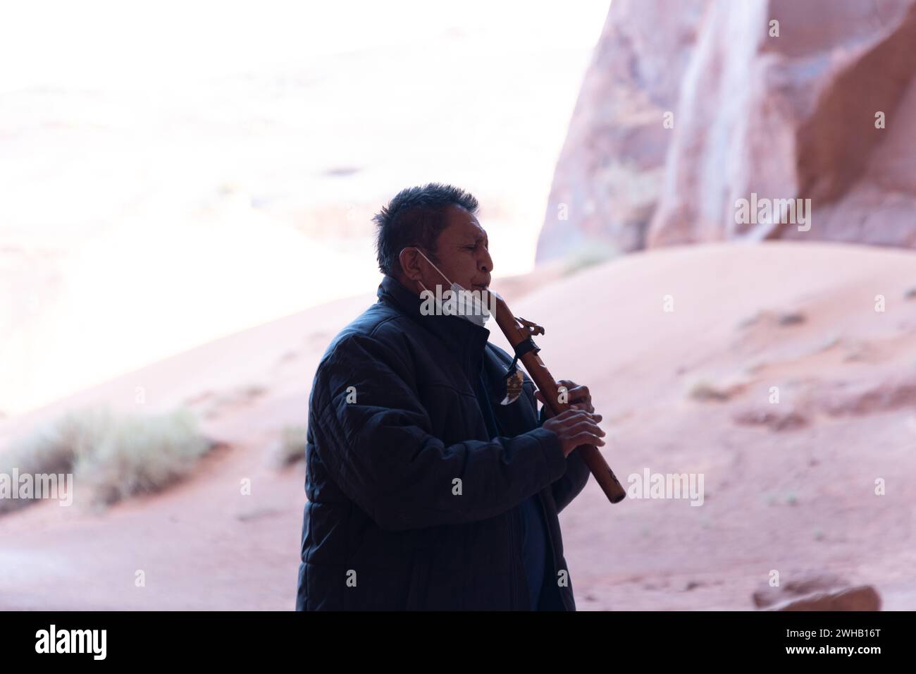 Navajo Native American playing the flute for the tourists at Monument ...