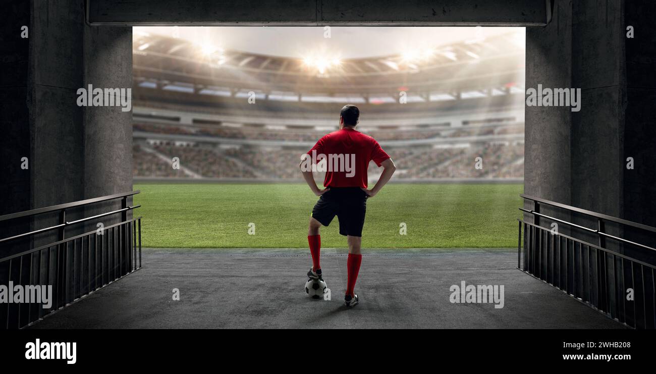 Back view of man, football player standing with ball and looking on ...