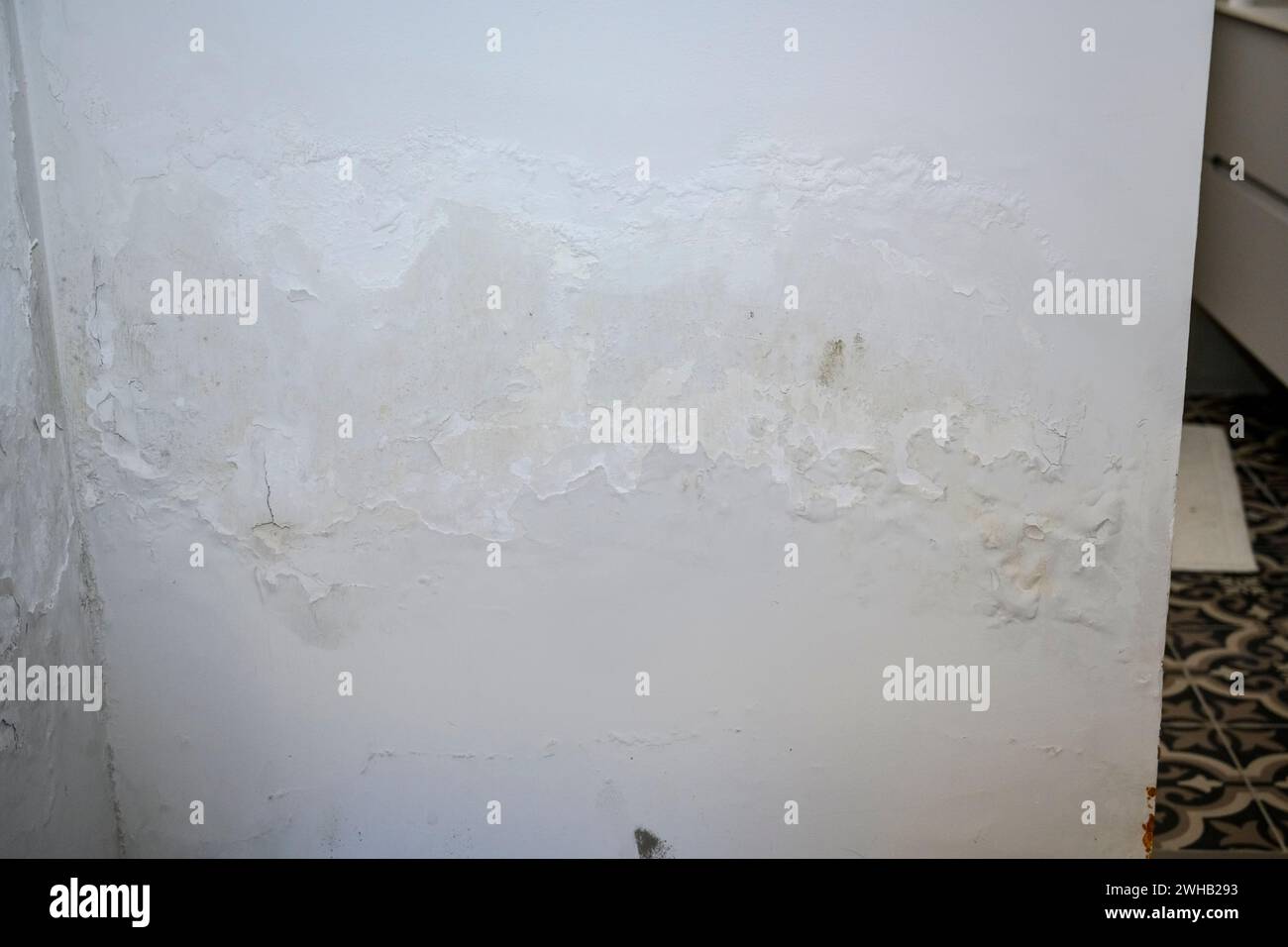 Paint is peeling off an interior wall this was caused by dampness due ...