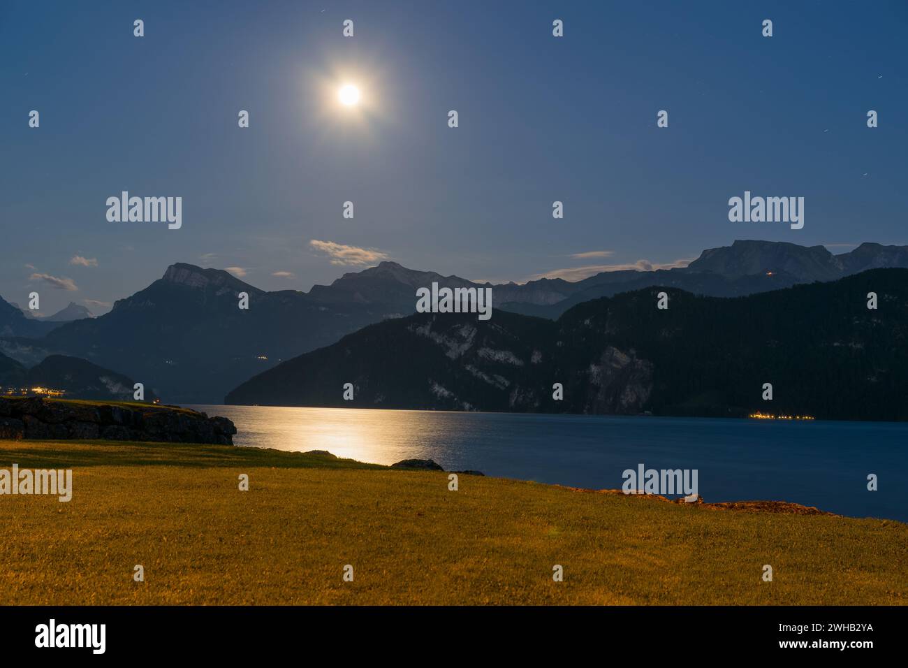 Moonlit scene at lake Lucerne with clear sky and mountains in the ...