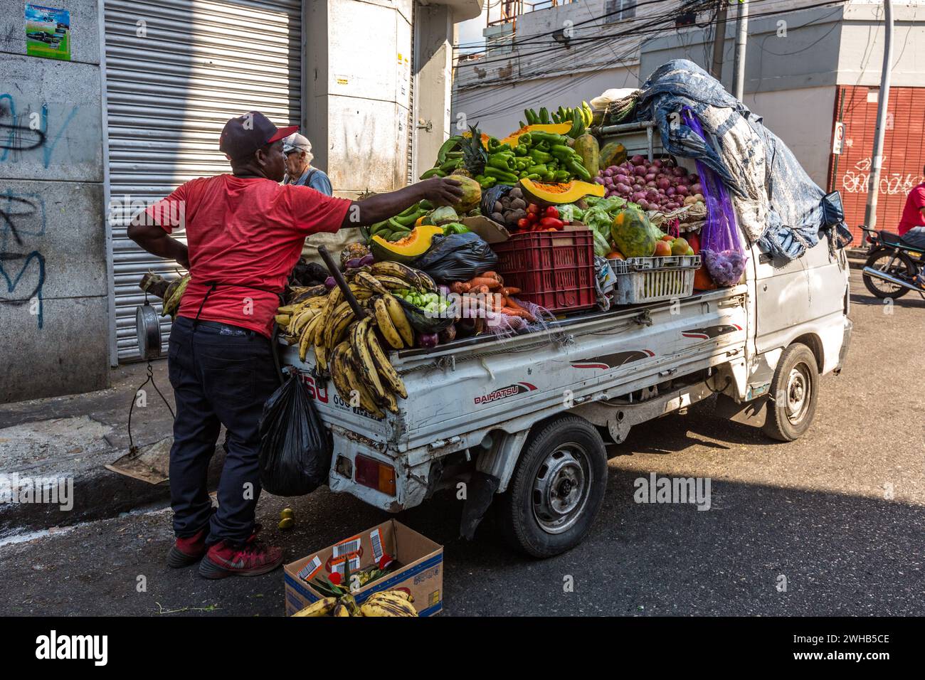 A mobile produce truck selling fruits and vegetables on the street in ...