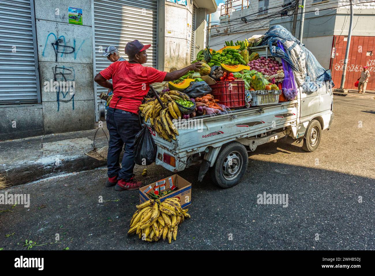 A mobile produce truck selling fruits and vegetables on the street in ...