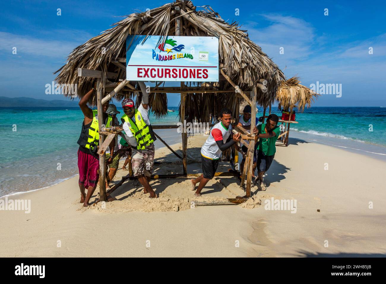 Guides move a shelter on tiny Paradise Island, a small sandbar island ...