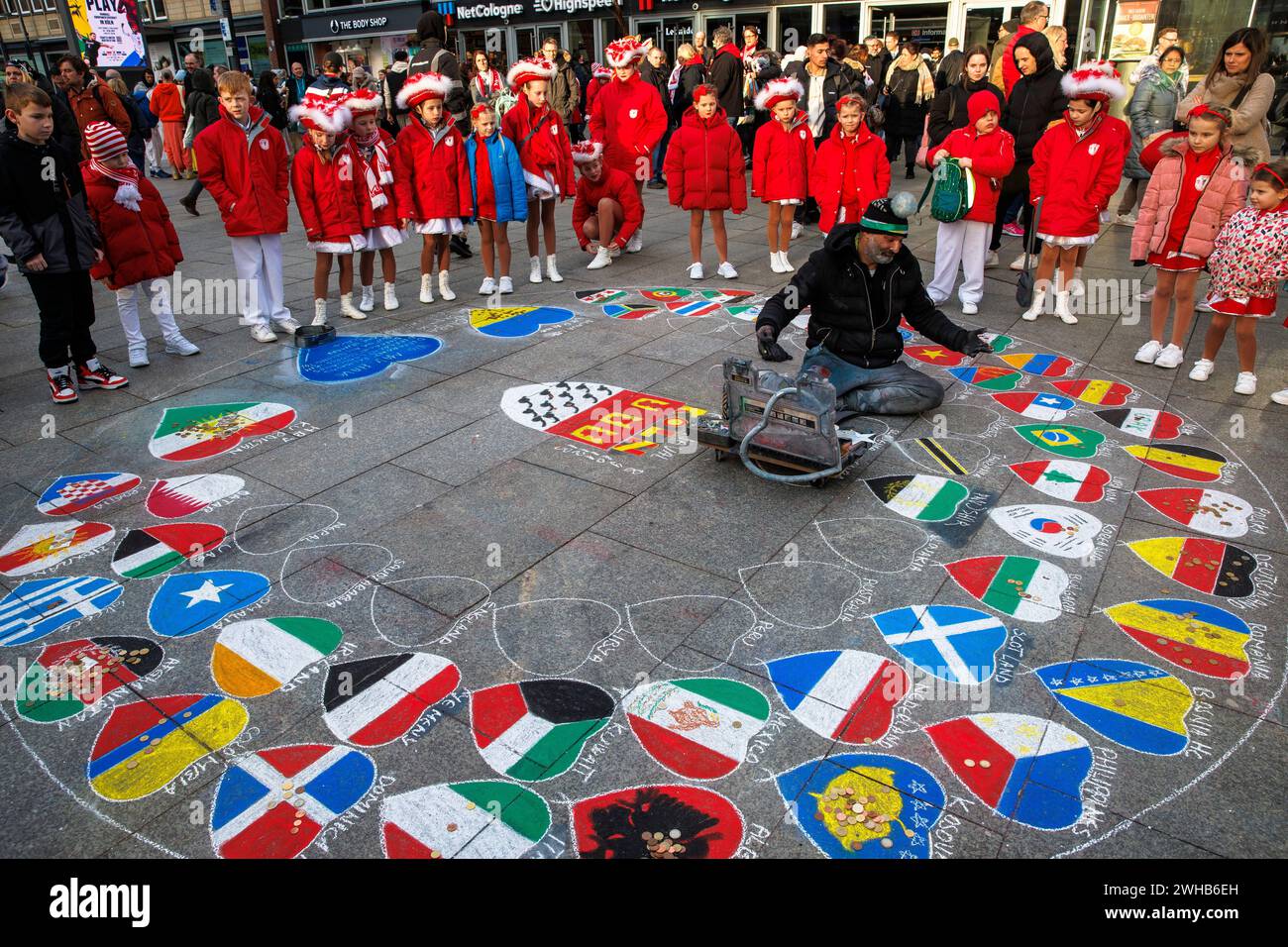 pavement painter in front of the central station, flags of different ...