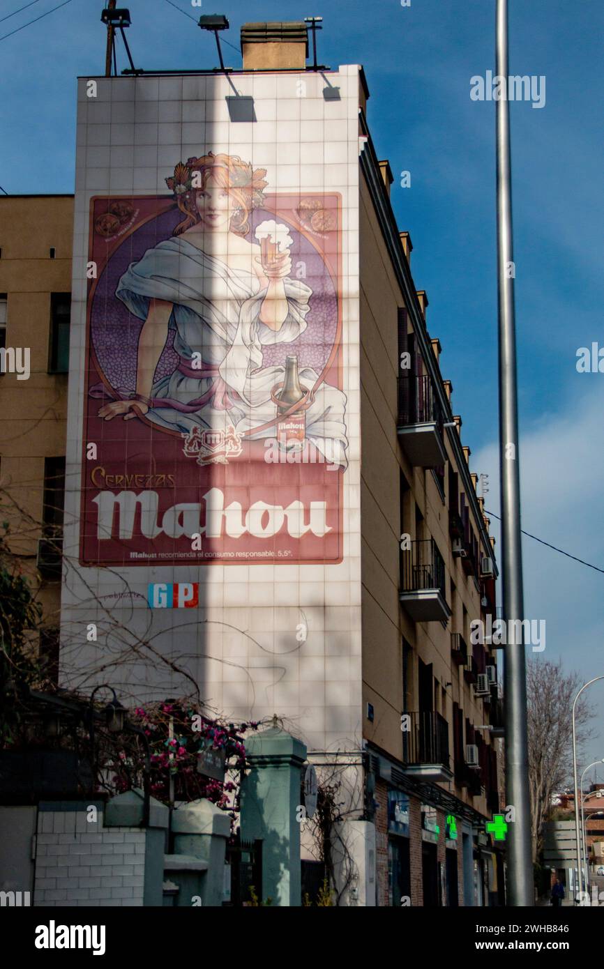 Mahou beer advertisement painted on a facade of a building on a street ...