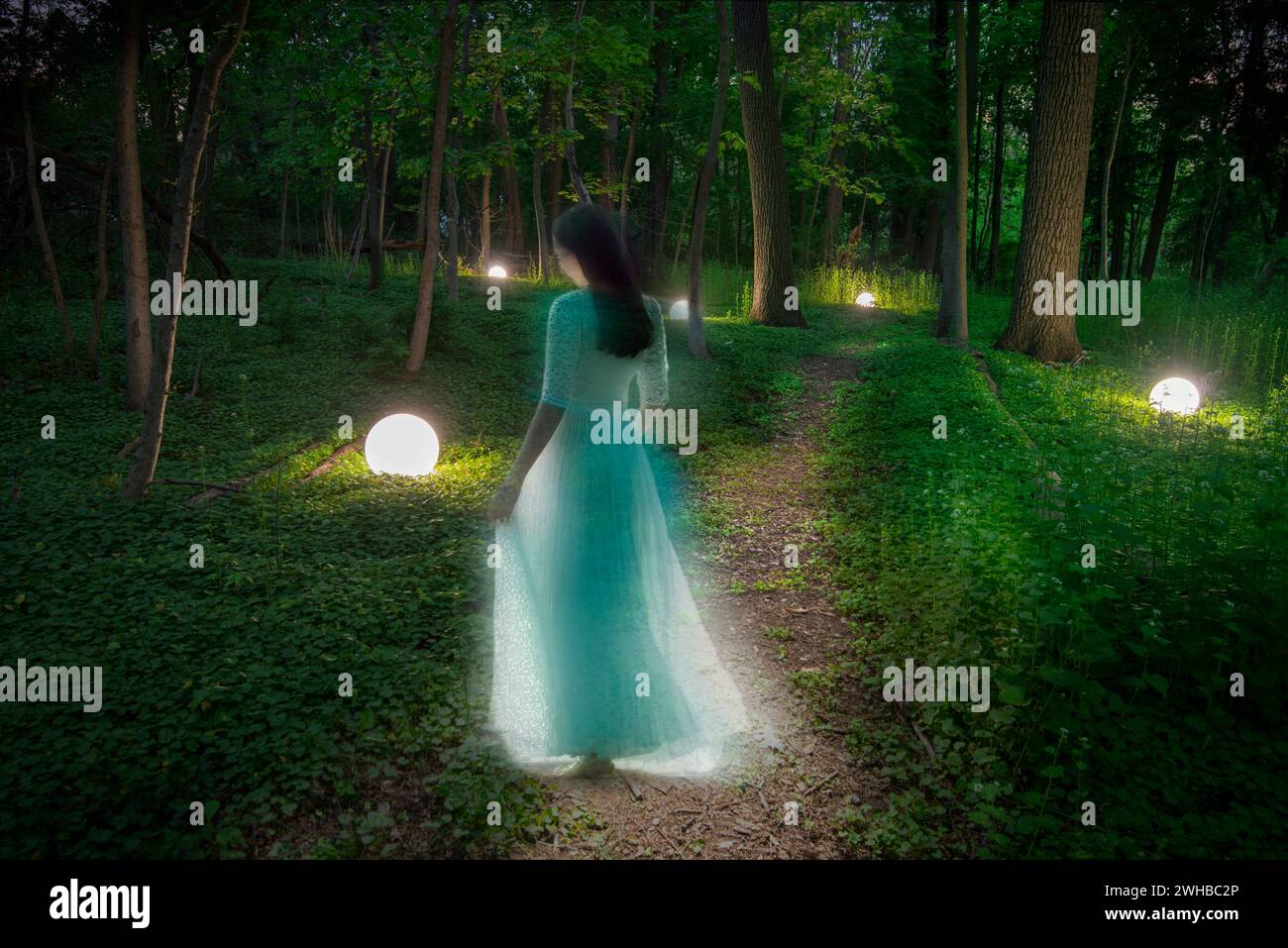 Woman in enchanted mythical forest with glowing orbs Stock Photo - Alamy