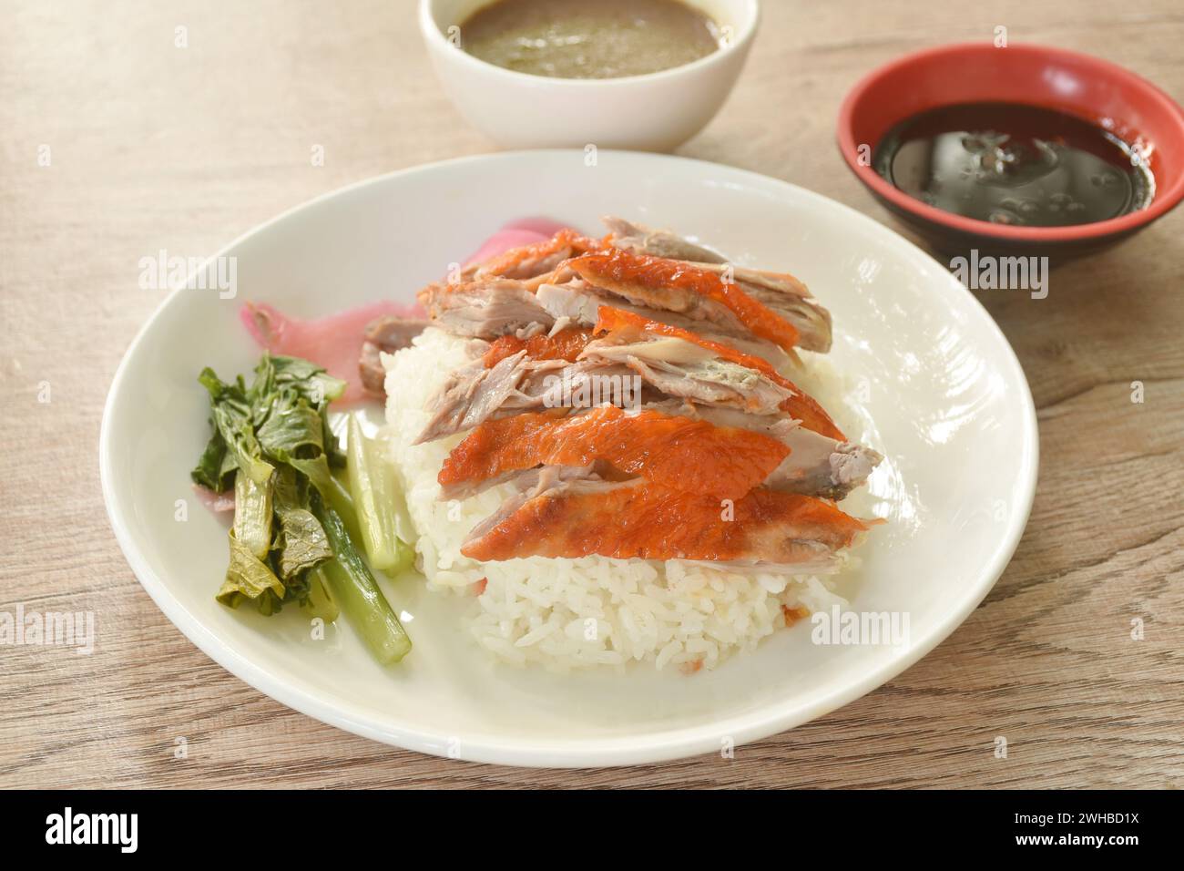 slice roasted duck topping rice with pink pickled ginger and boiled ...