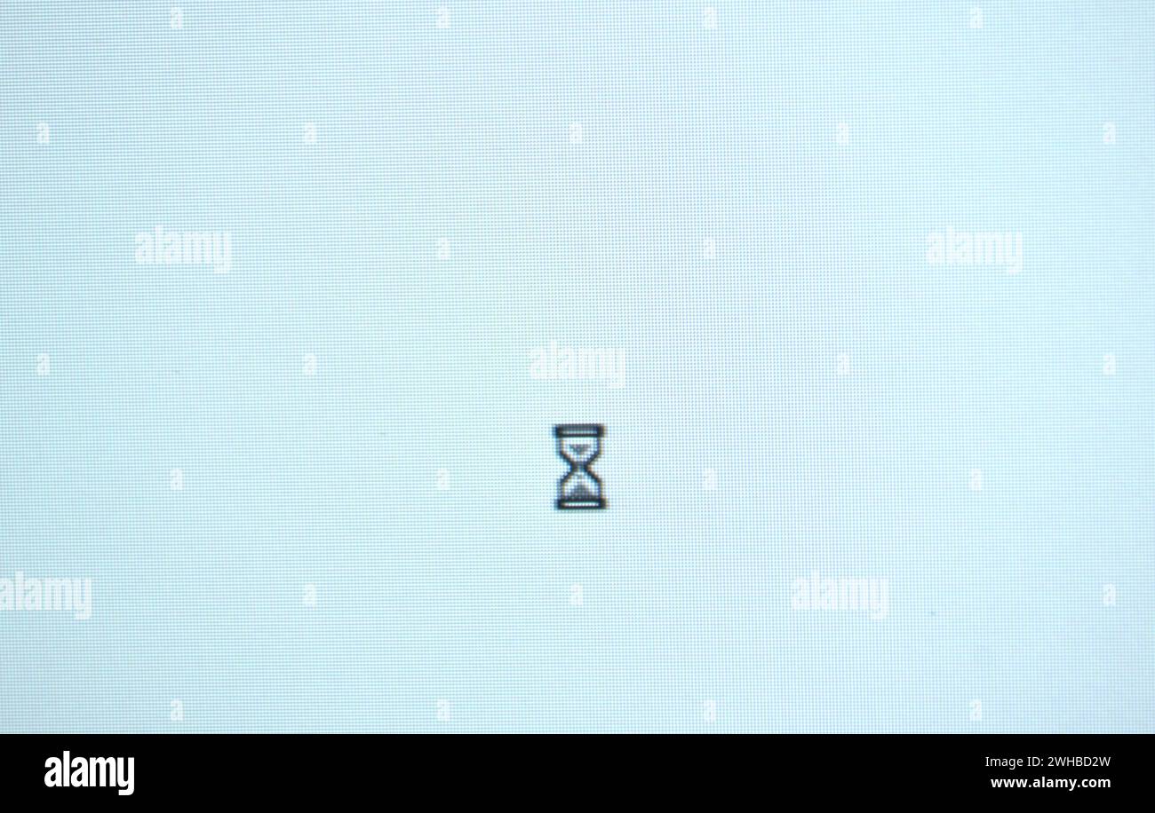 sand glass symbol computer mouse pointer on white LCD screen background ...