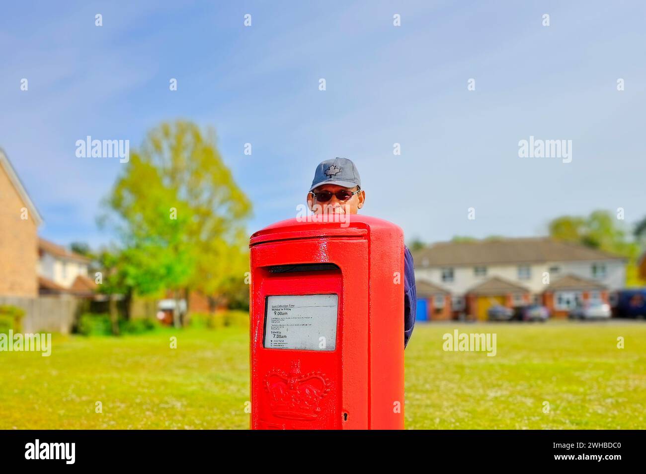 Hide and Seek with a Classic British Red Post Box Stock Photo - Alamy