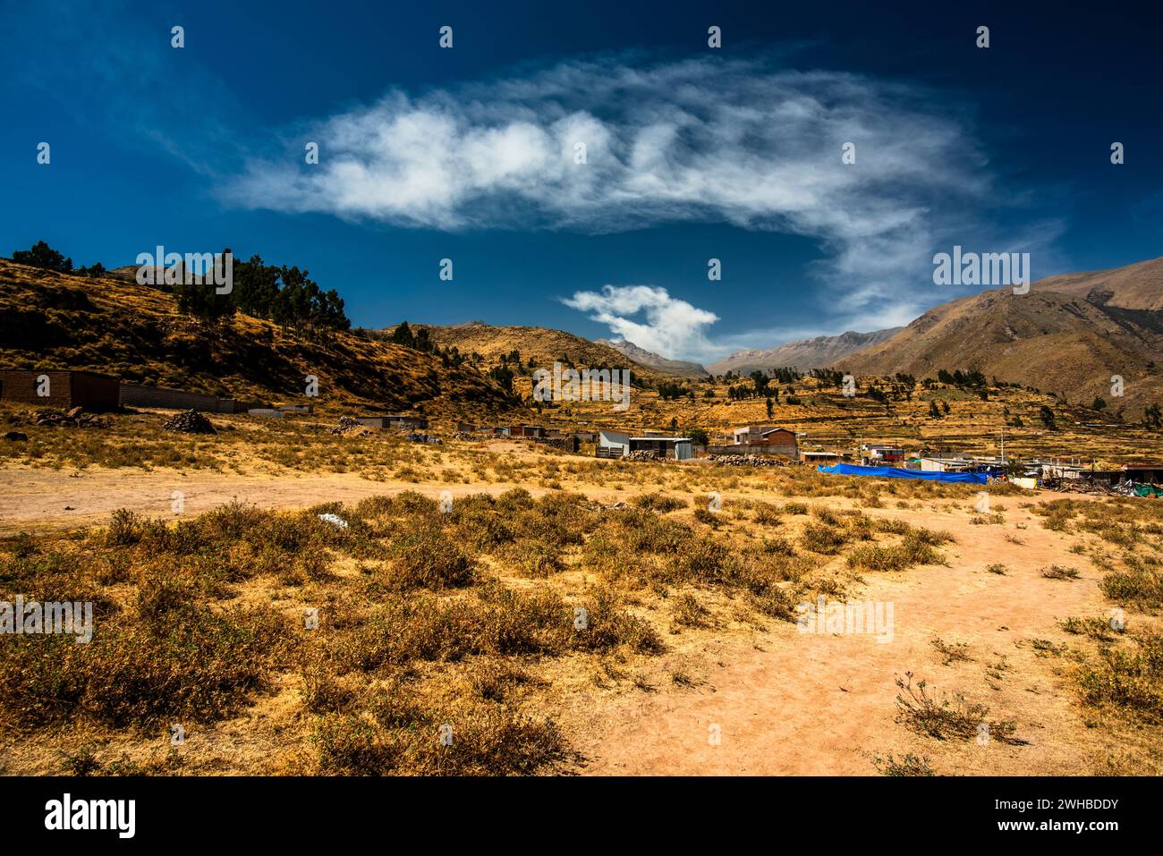 small village at dawn with blue sky and mountains in the background ...