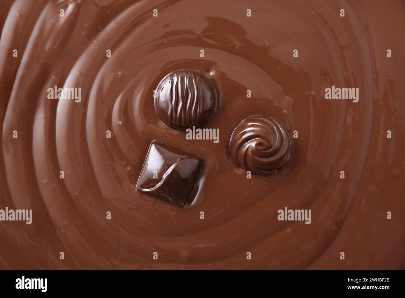 Three different dark chocolate bonbons dipped in chocolate cream. Top ...