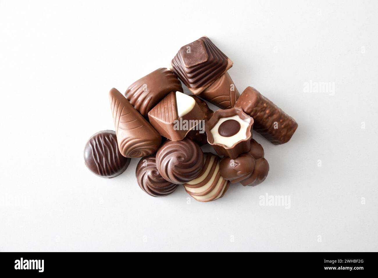 Assortment with stack of dark and milk chocolate bonbons isolated on ...