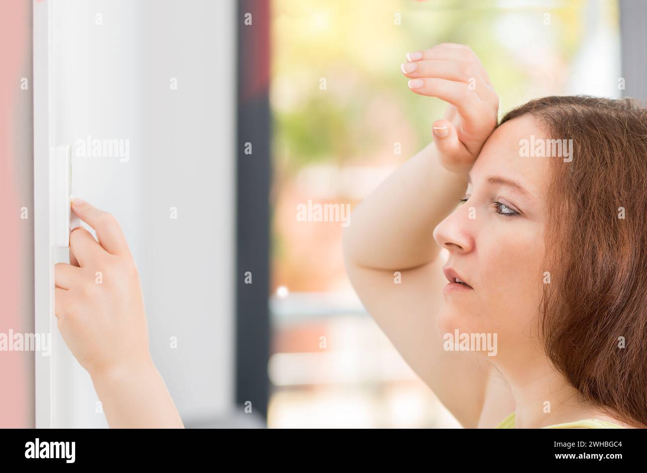 Shot of a side view portrait of a sad woman push button digital ...