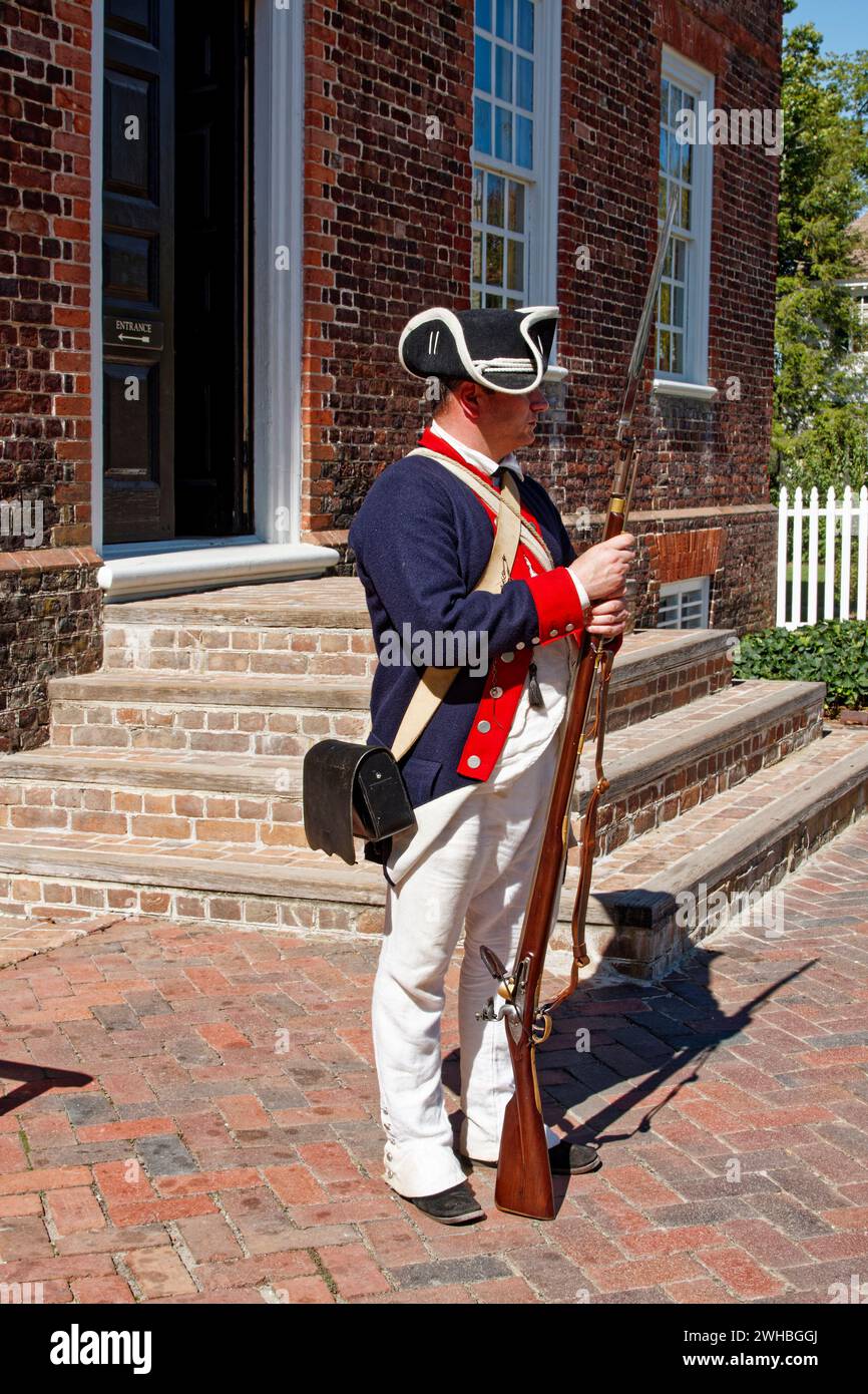 Colonial soldier, historical interpreter, standing outside brick ...