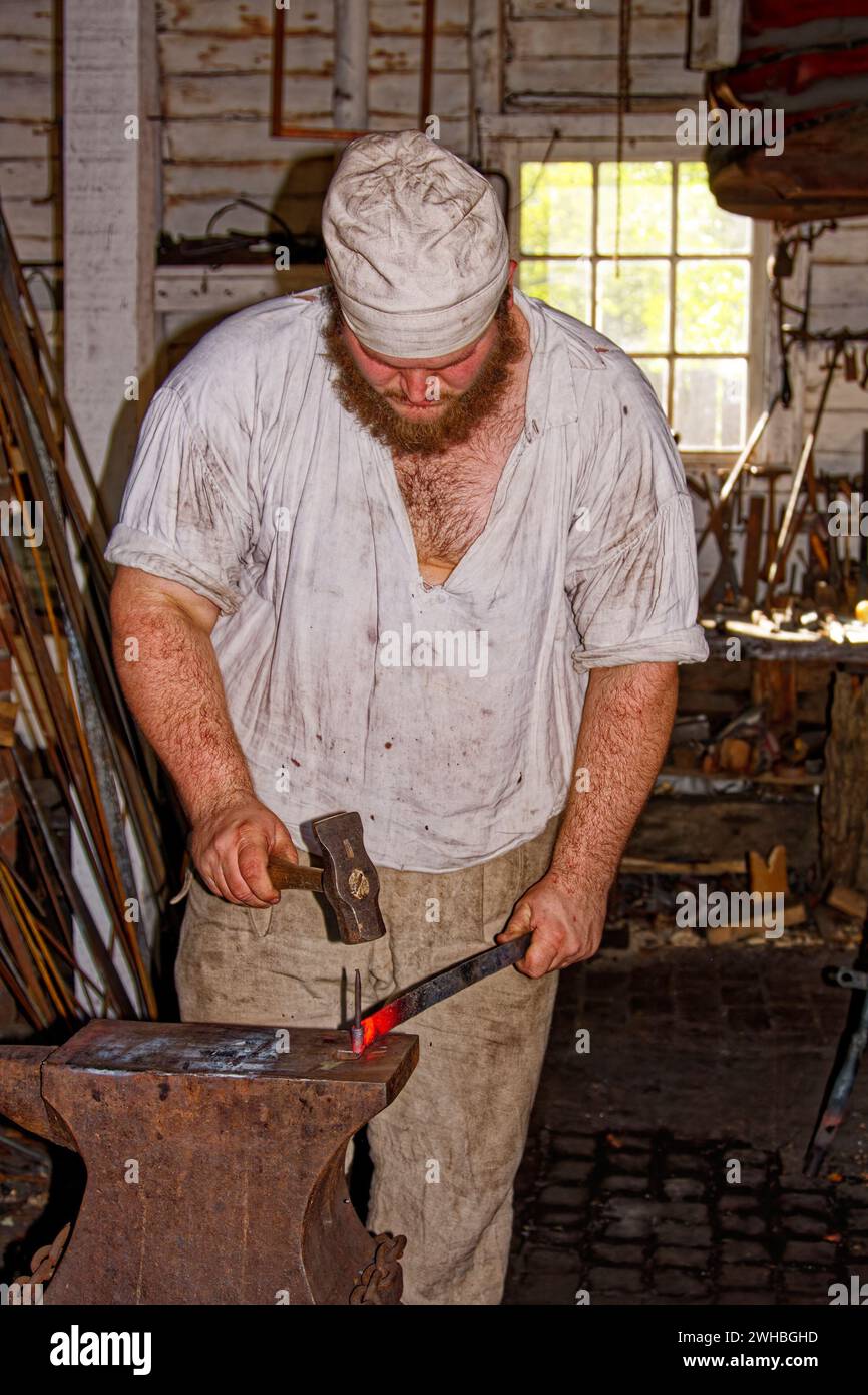 Blacksmith Shop, man working, historic reenactor, hammering hot metal ...