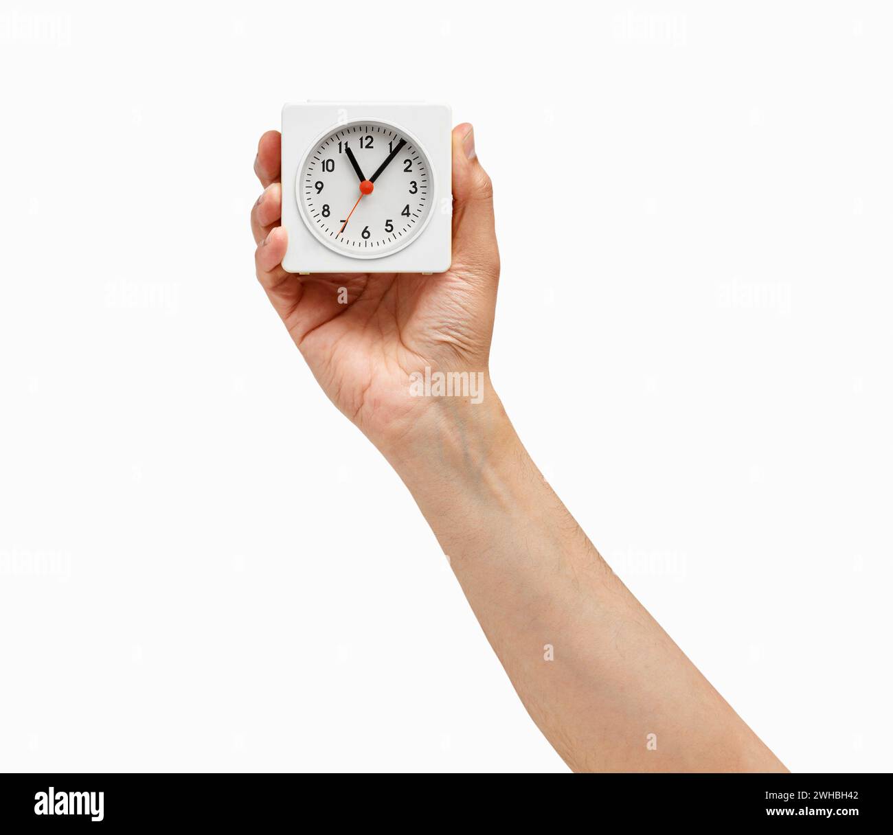 male hand holding alarm clock on white background Stock Photo - Alamy