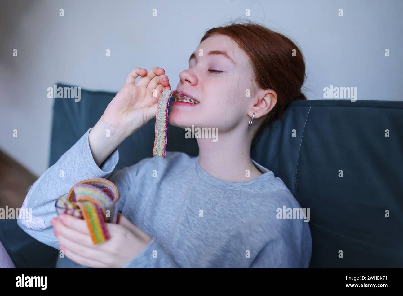 girl eating swedish candy at home Stock Photo - Alamy