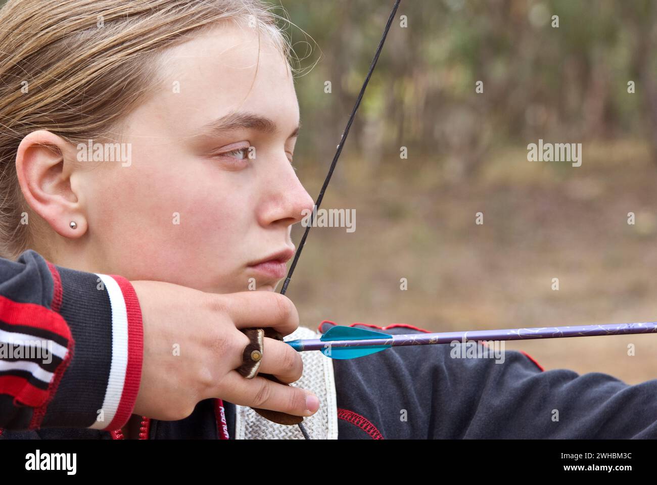 Girl firing an arrow Stock Photo - Alamy