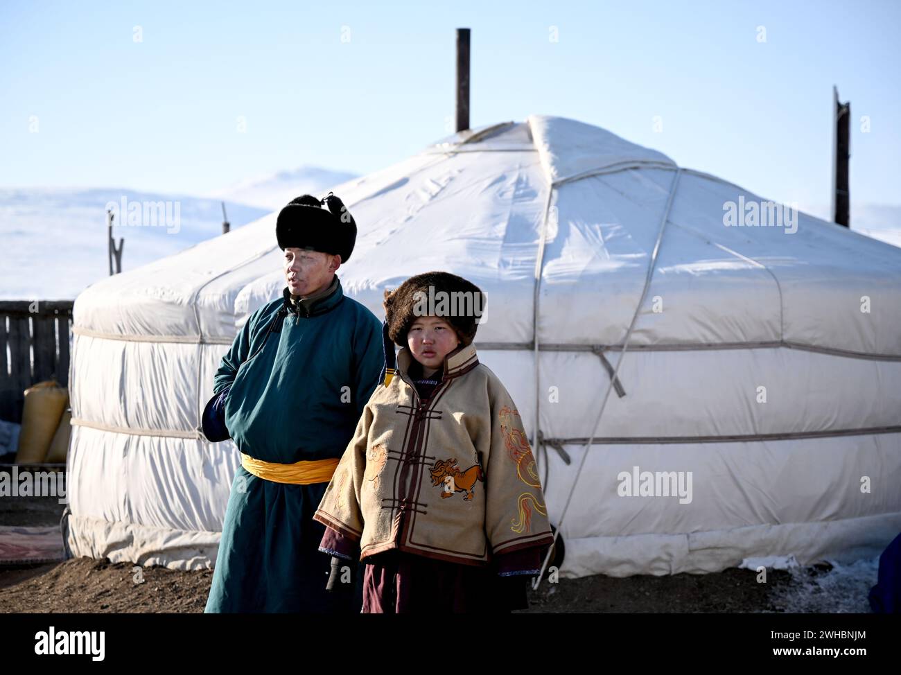 Tuv Aimak, Mongolia. 07th Feb, 2024. Nomads stand in front of a yurt ...