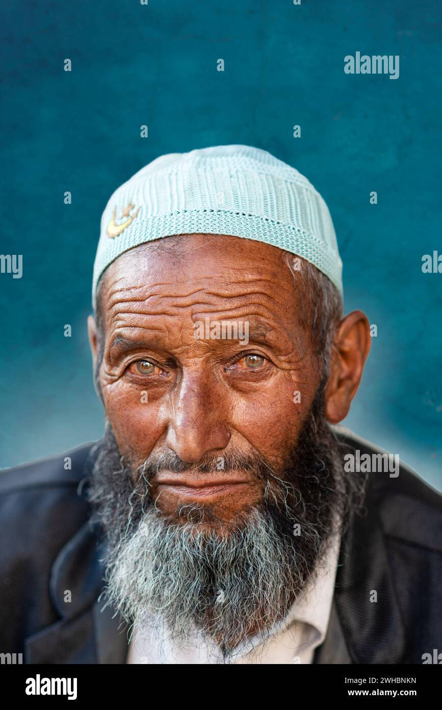 A portrait of an elderly Muslim Ladakhi men wearing a skullcap also ...