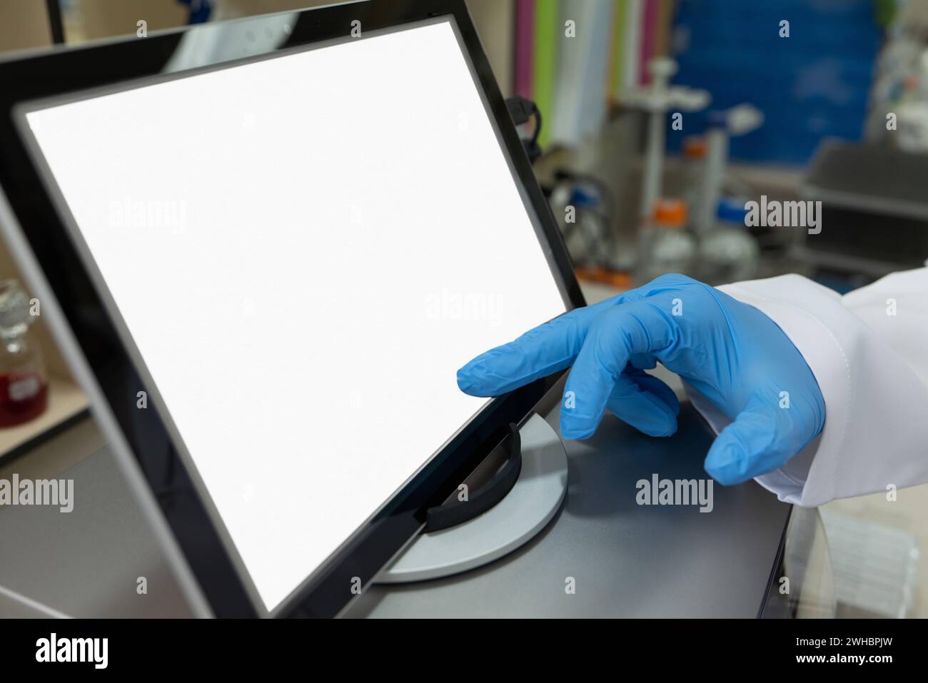 Doctor reviewing patient data on touchscreen monitor Stock Photo - Alamy