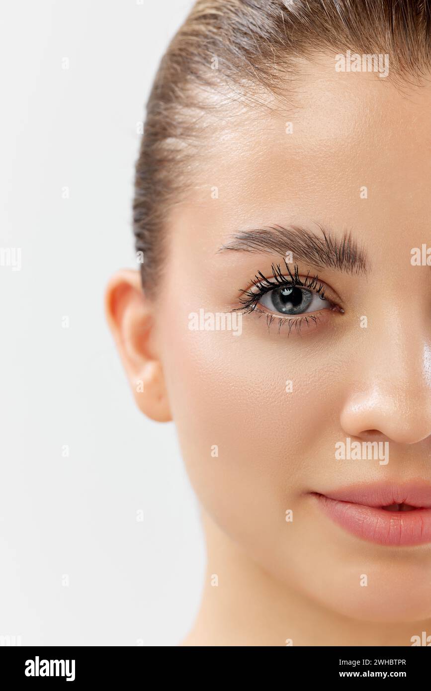 Half-faced portrait of beautiful young woman with clear face, long ...