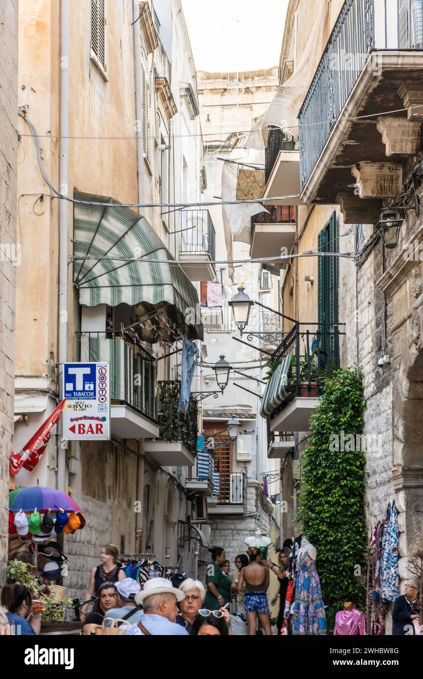 The charm of the alley of the historic center of Bari. Tourists along ...